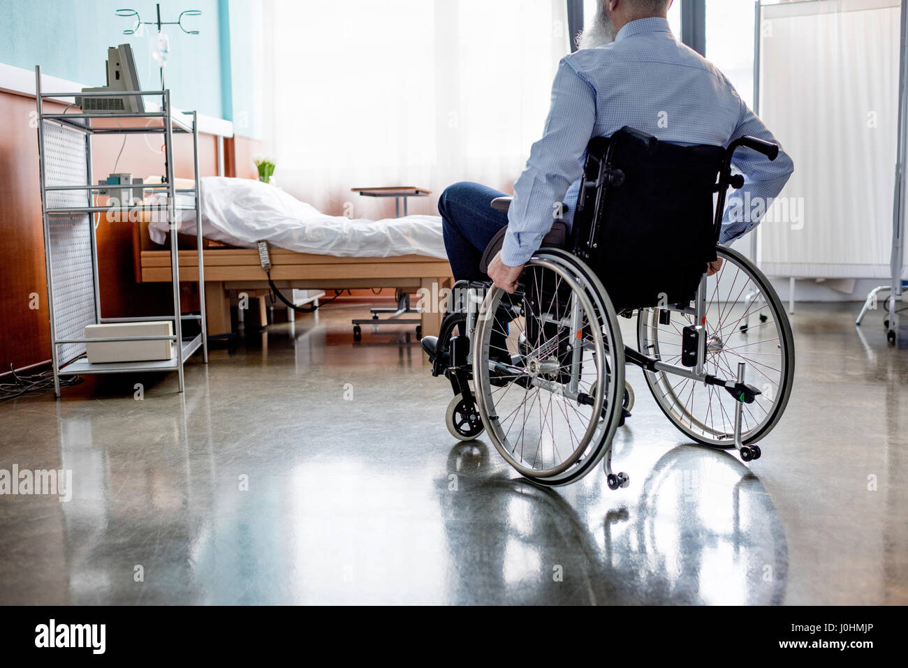 Back view of senior male patient in wheelchair at hospital room Stock ...