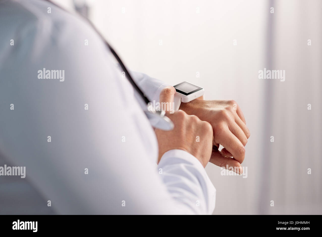 Partial view of female doctor using smartwatch in hospital Stock Photo ...