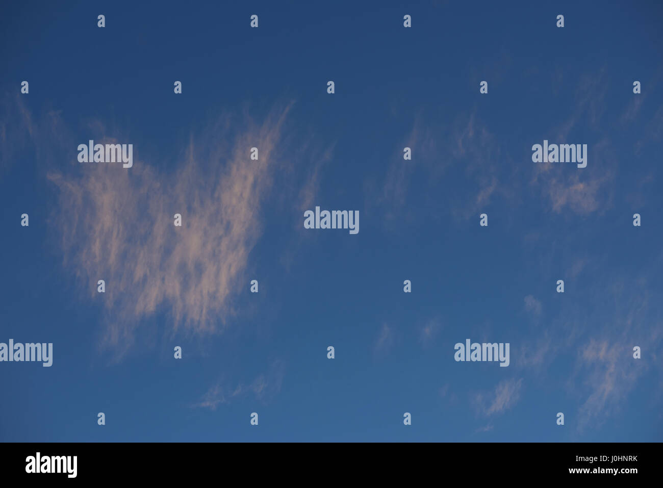 Orange color cloud on sunset blue sky background Stock Photo - Alamy