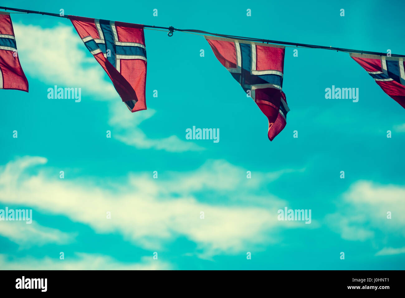 Norwegian flags against blue sky Stock Photo - Alamy