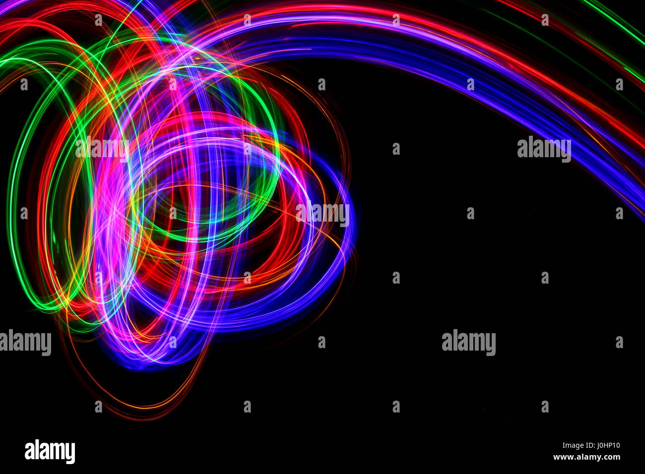Light painting photography on a black background. Abstract neon swirls ...