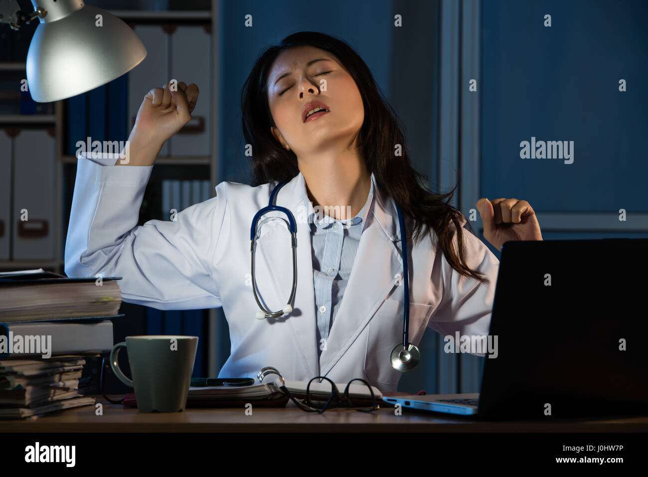 young worried doctor having bad diagnosis and stretch at night ...