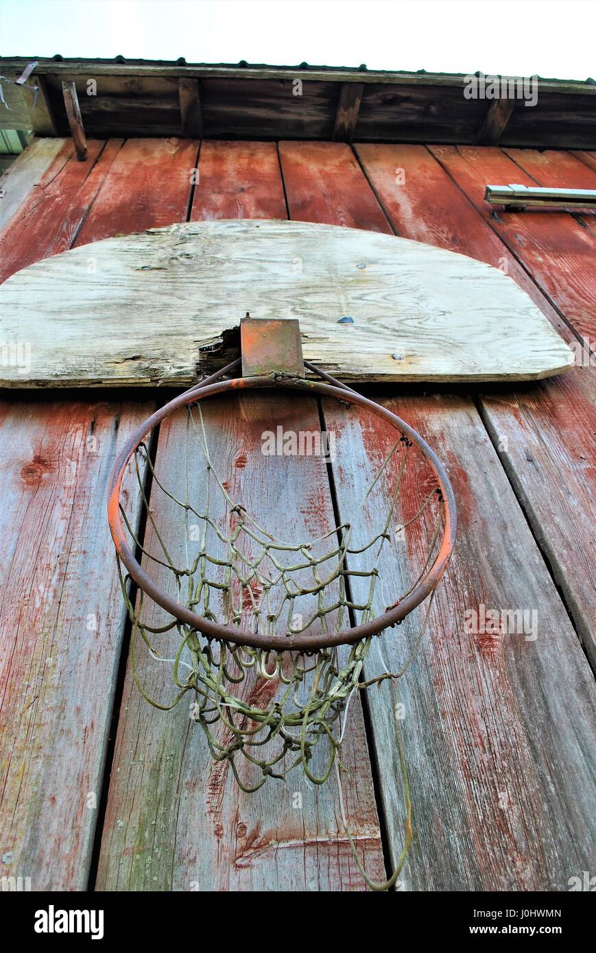 Old basketball hoop on red barn wall Stock Photo - Alamy