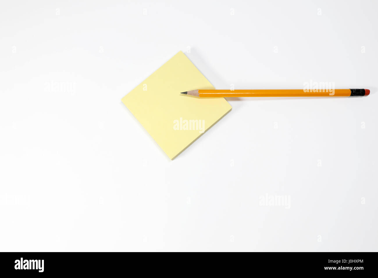 Pencil on memory note isolated on white background Stock Photo - Alamy
