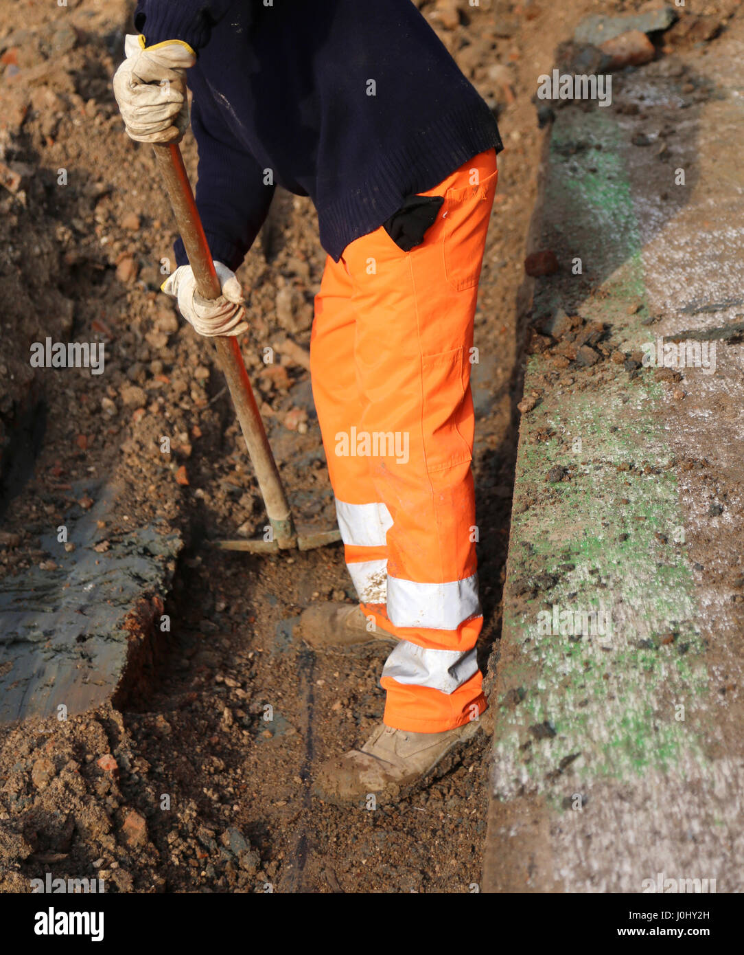 man at work in the trench in the roadwork with the shovel inside Stock ...