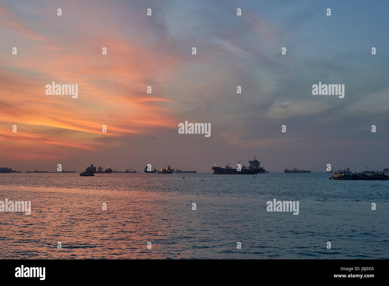 Sunrise Over Cargo Ships At Anchor In The Singapore Straits Stock Photo ...