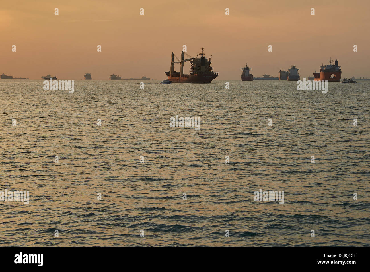 Sunrise Over Cargo Ships At Anchor In The Singapore Straits Stock Photo ...