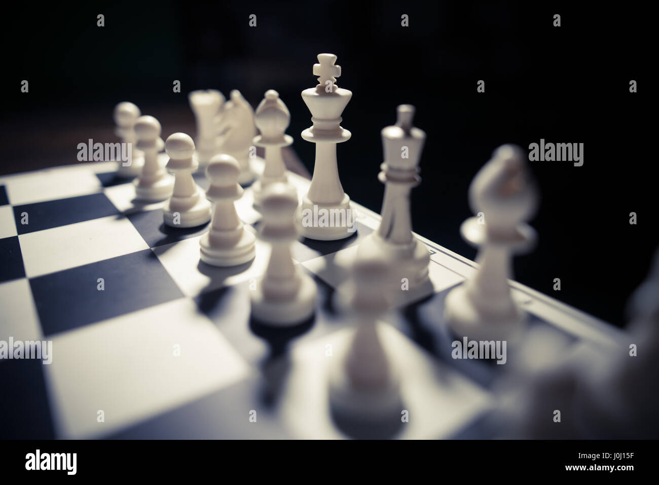 Image of the white pieces on a chess board, with shallow depth of field ...