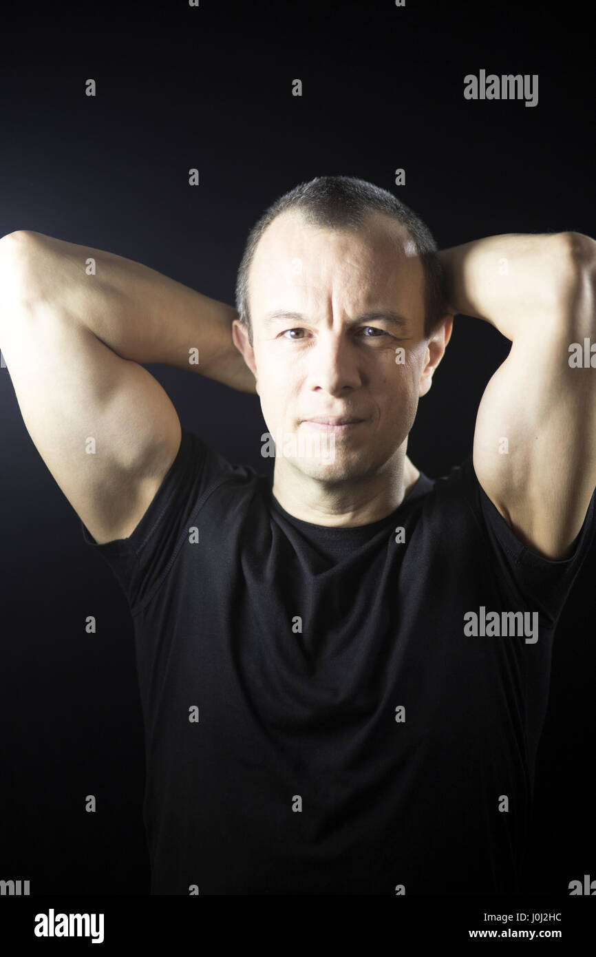 Attractive handsome slim healthy man aged in 40's in black t-shirt ...