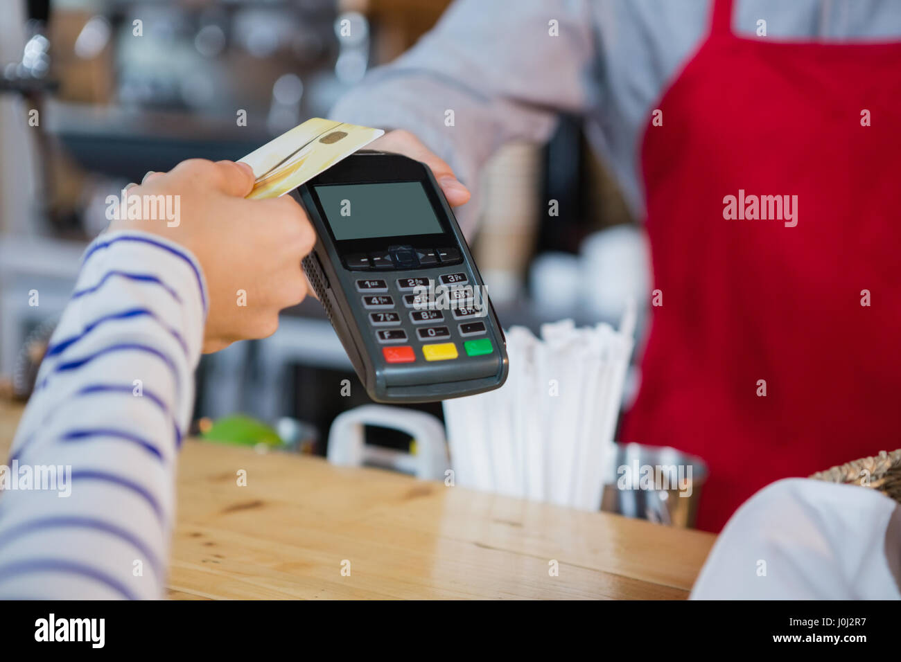 Woman making payment through credit card at counter in cafÃƒÂ© Stock ...