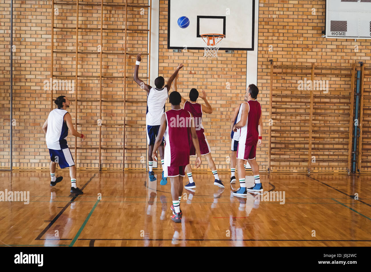 Determined basketball players playing in the court Stock Photo - Alamy
