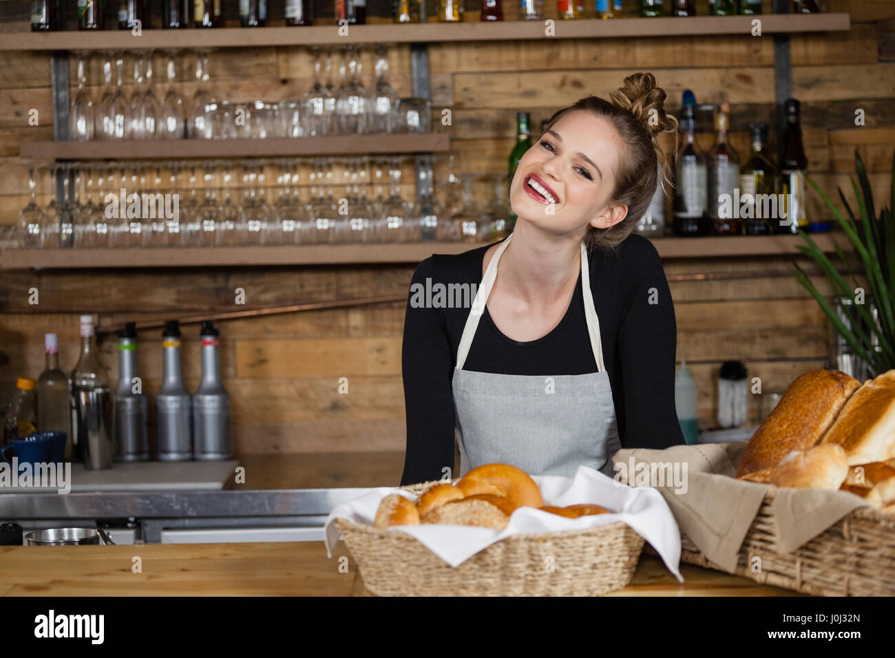 Portrait of cheerful owner standing by counter at cafe shop Stock Photo ...