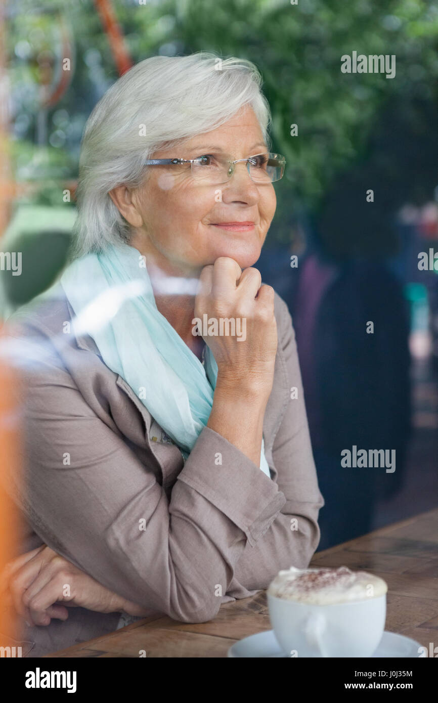 Sitting holding smiling hand on chin food and drink communication hi ...