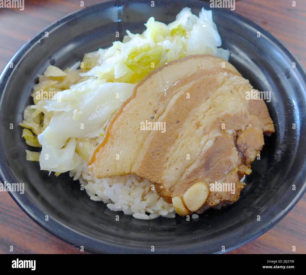 Braised pork on rice closeup Stock Photo - Alamy