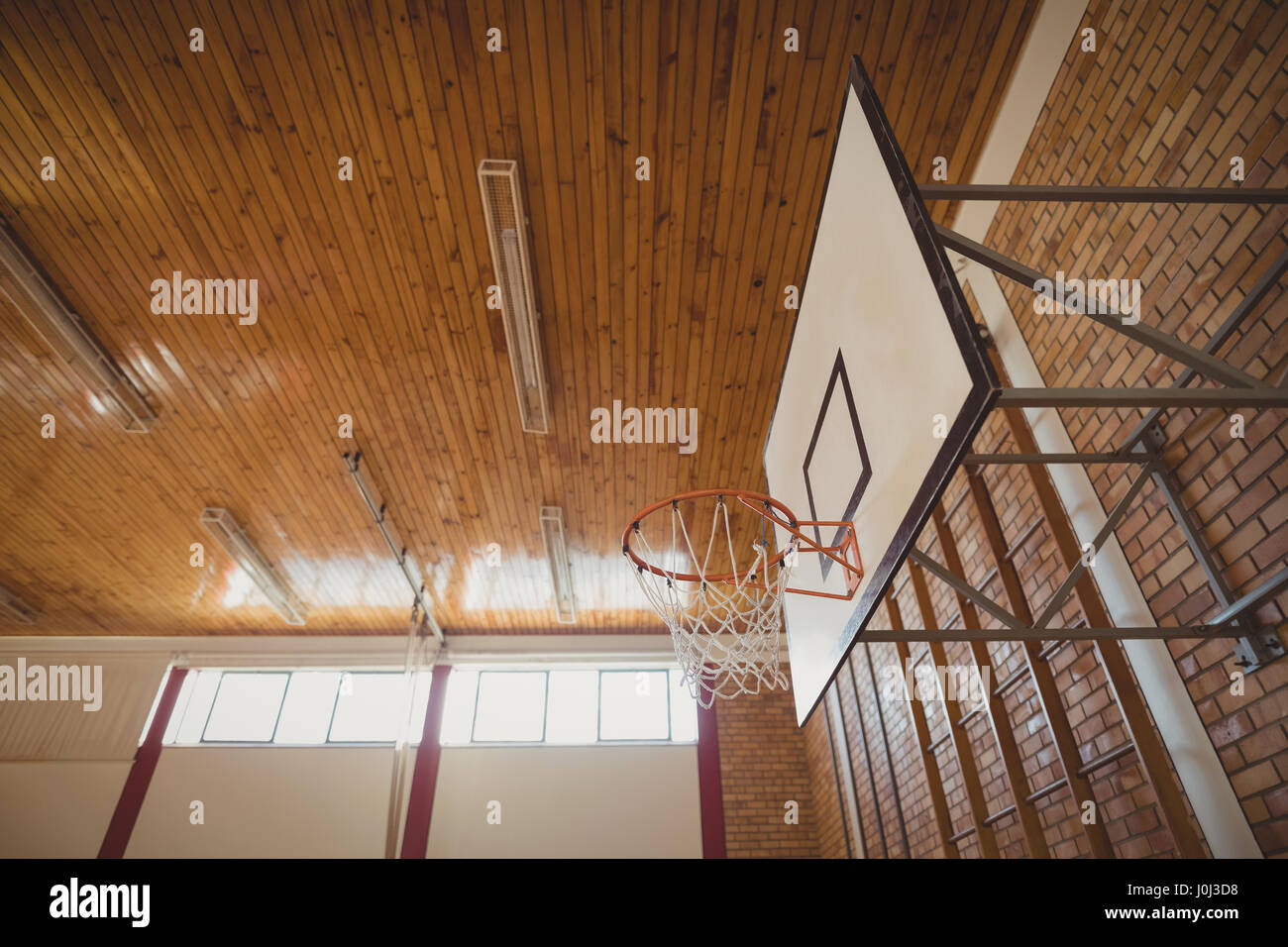Basket ball hoop in empty basketball court Stock Photo - Alamy
