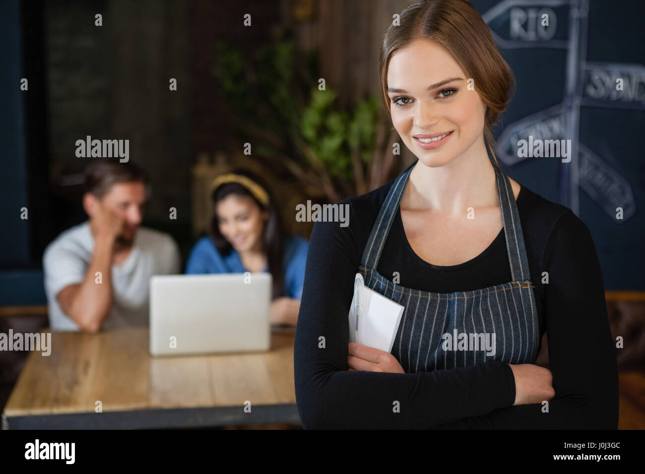 Portrait of smiling owner standing against customer at cafe shop Stock ...