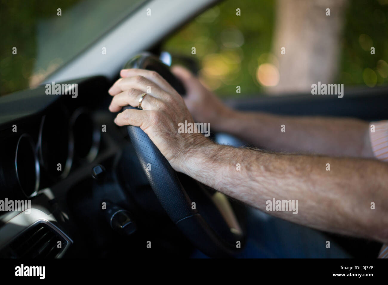 Cropped hands of senior man driving car Stock Photo - Alamy