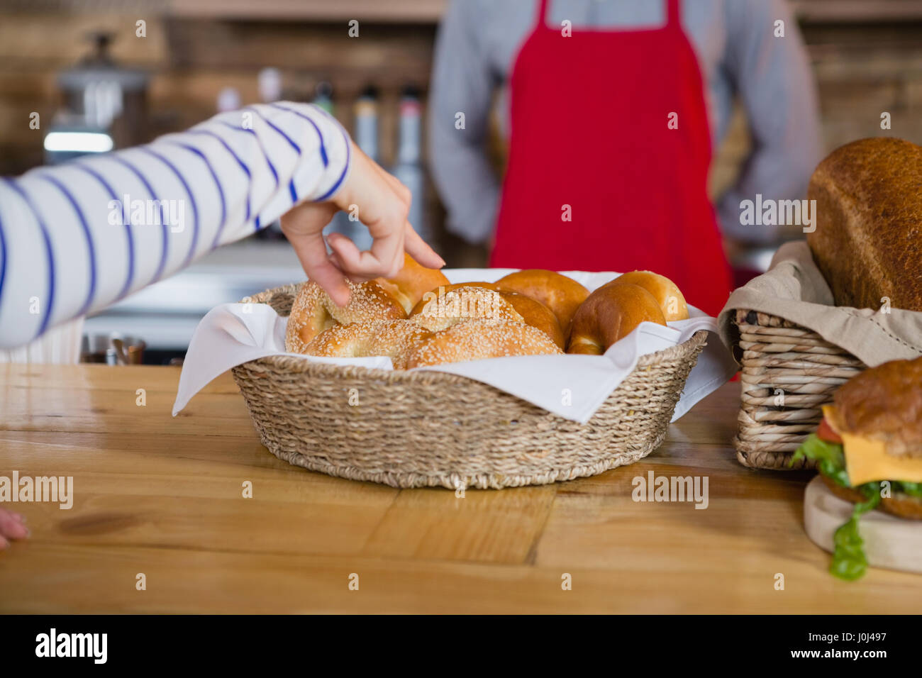 Customer pointing towards buns at counter in cafÃƒÂ© Stock Photo - Alamy