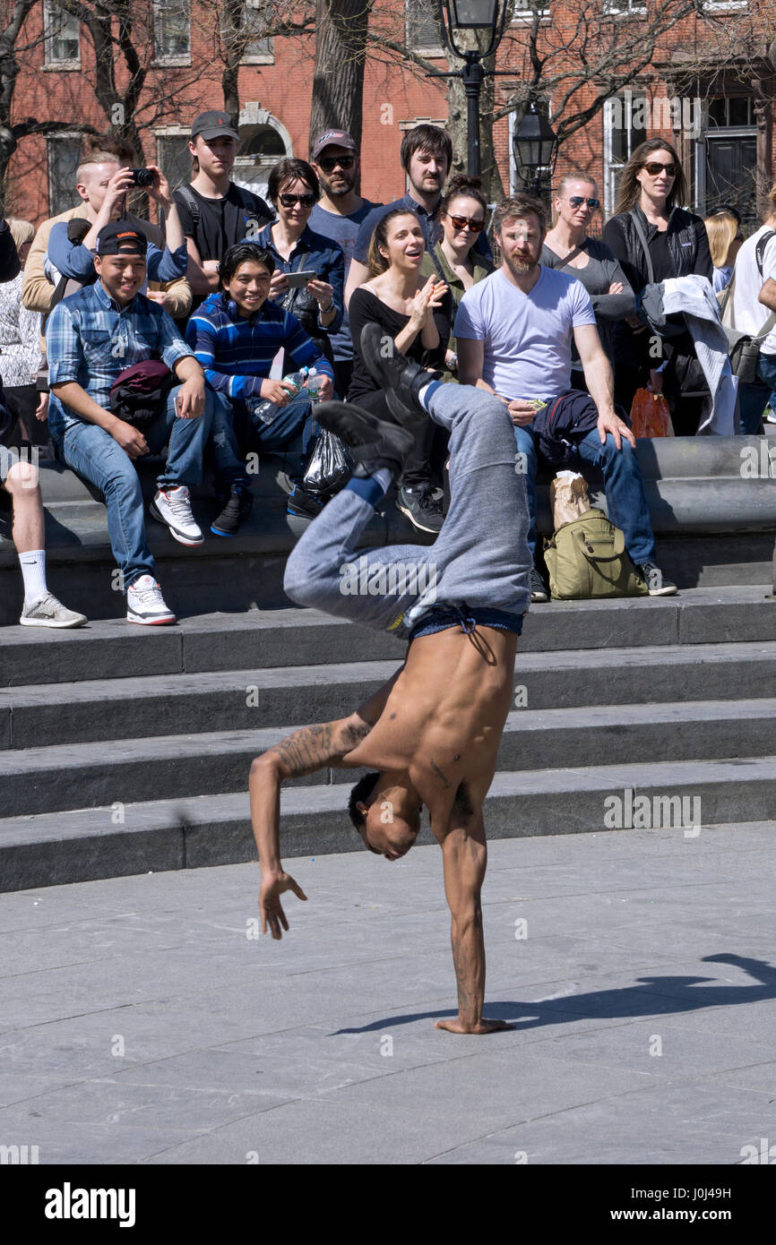 A shirtless acrobatic dancer performing for tips at Washington Square ...
