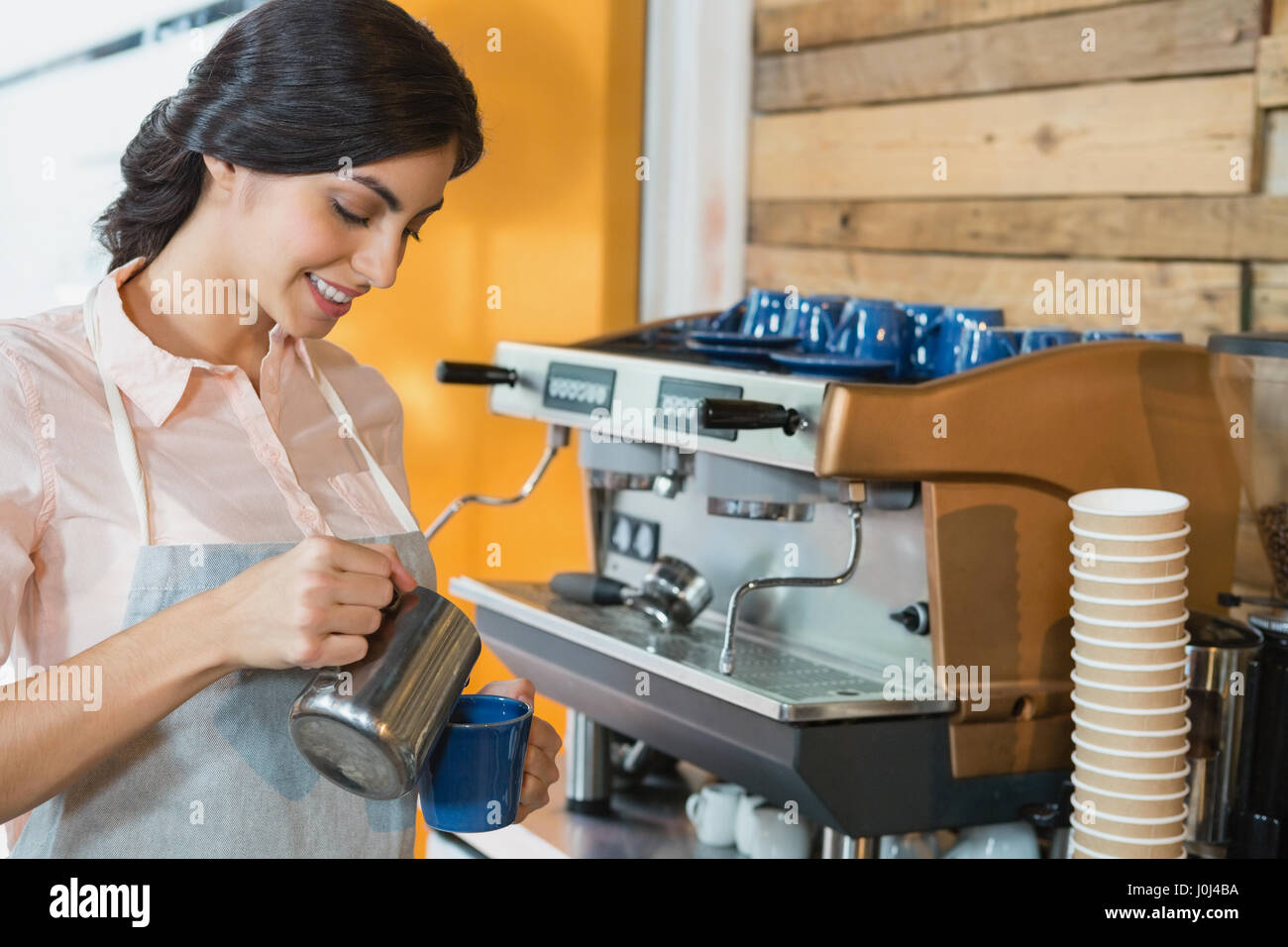 Waitress pouring coffee into cup in cafÃƒÂ© Stock Photo - Alamy