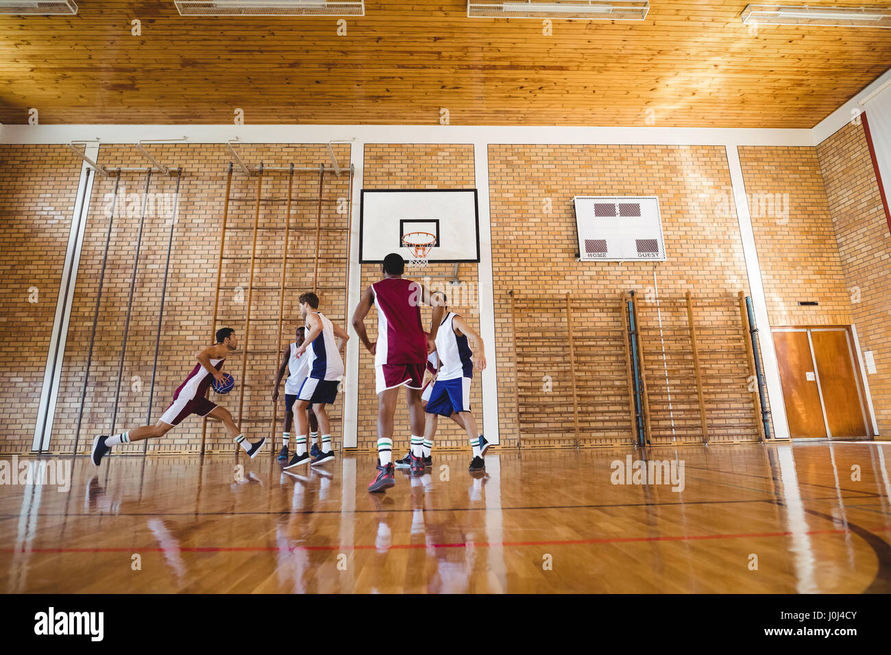 Determined basketball players playing in the court Stock Photo - Alamy