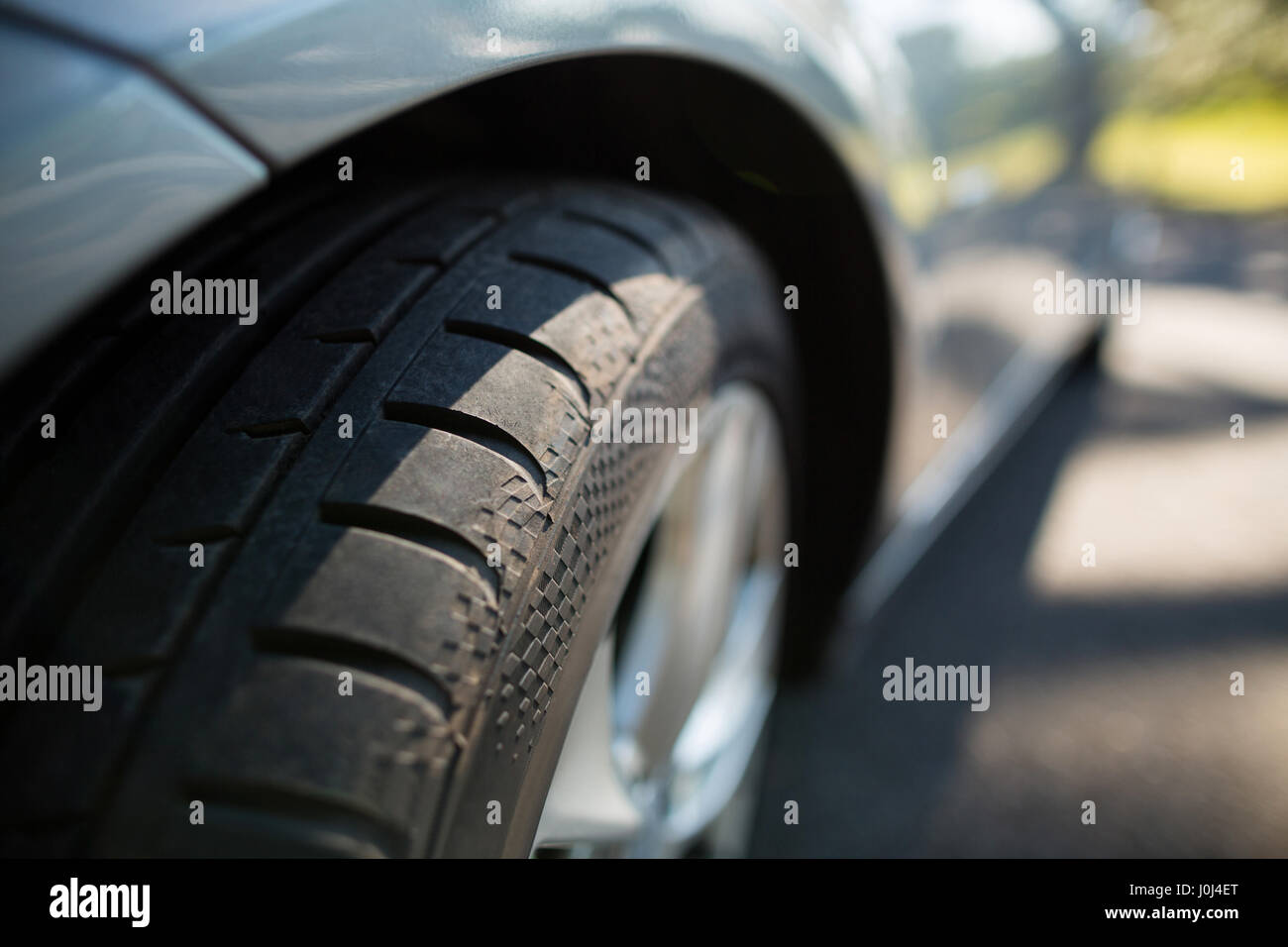 Close up of car wheel on road Stock Photo - Alamy