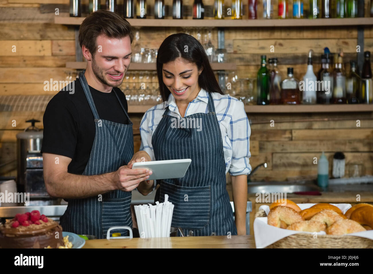 Waiter and waitresses using digital tablet at counter in cafÃƒÂ© Stock ...