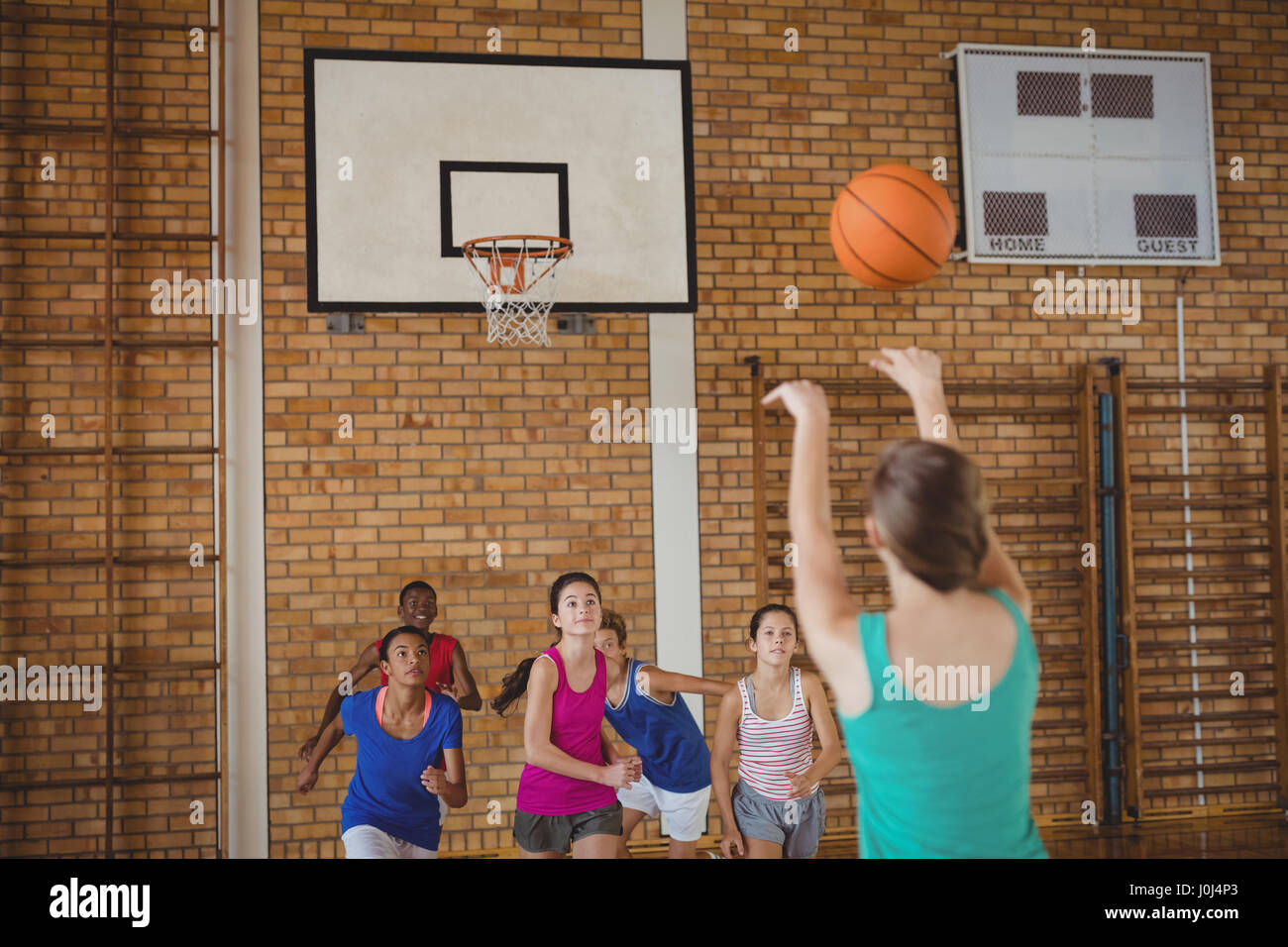 Determined high school kids playing basketball in the court Stock Photo ...