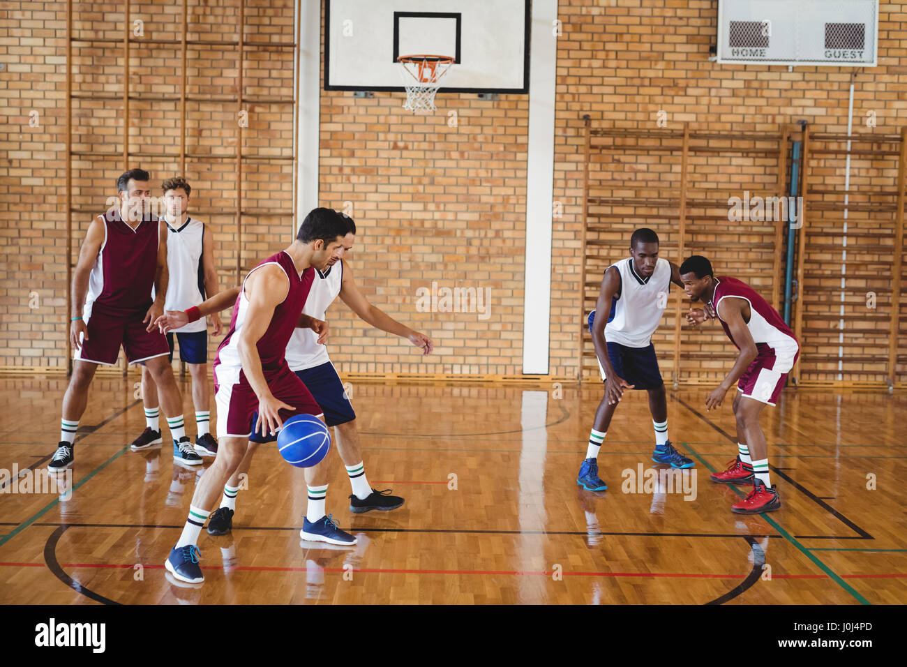 Determined basketball players playing in the court Stock Photo - Alamy