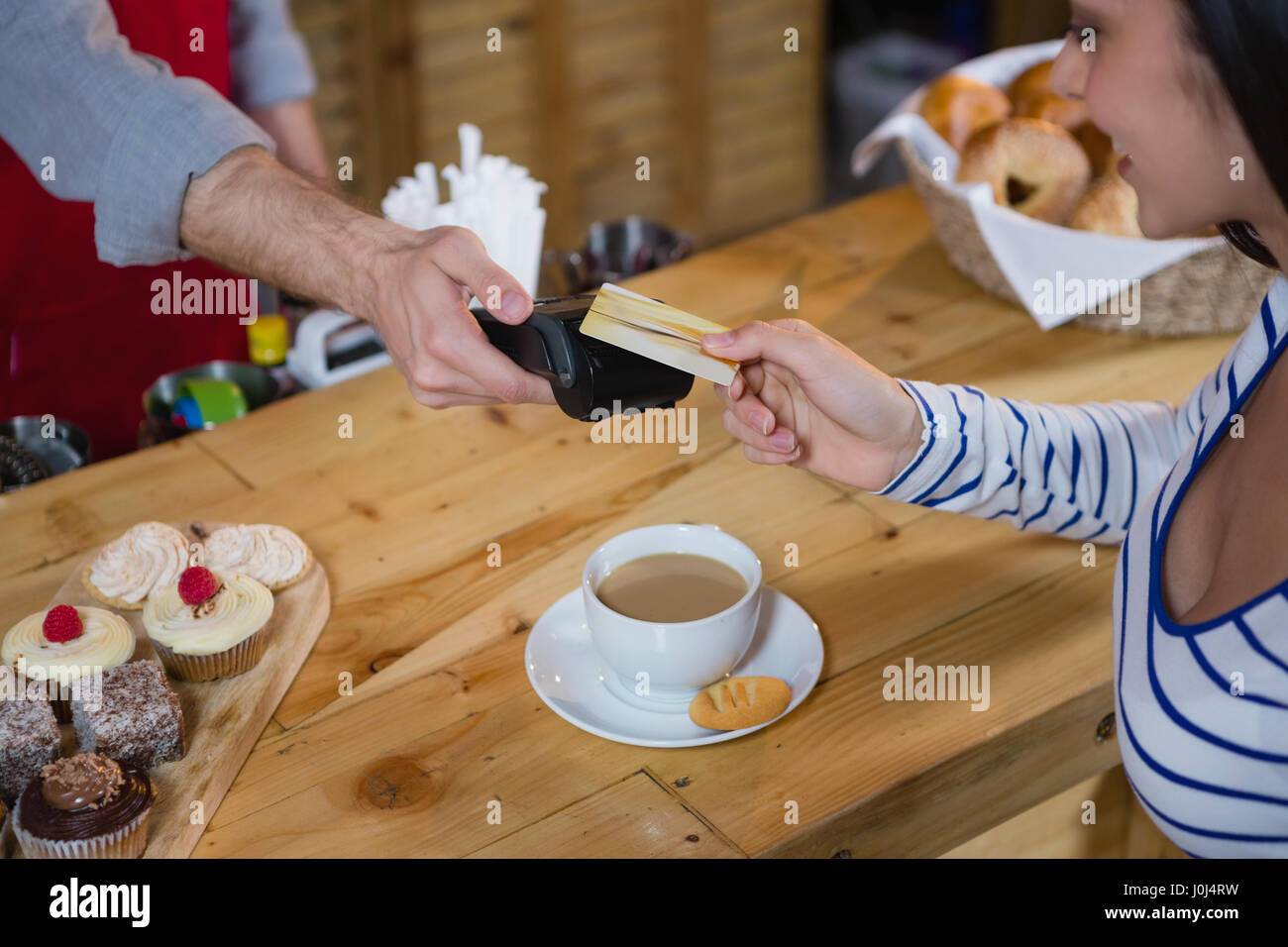 Woman making payment through credit card at counter in cafÃƒÂ© Stock ...