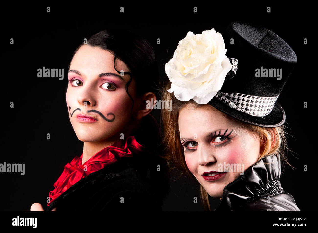 Two women styled for a gothic circus look Stock Photo - Alamy
