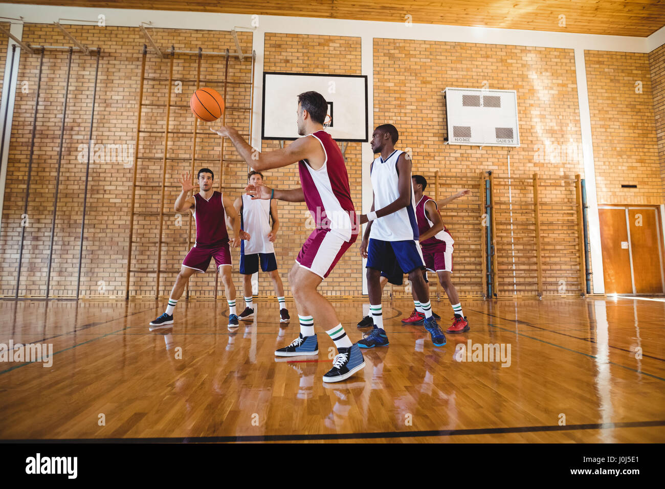 Determined basketball players playing in the court Stock Photo - Alamy