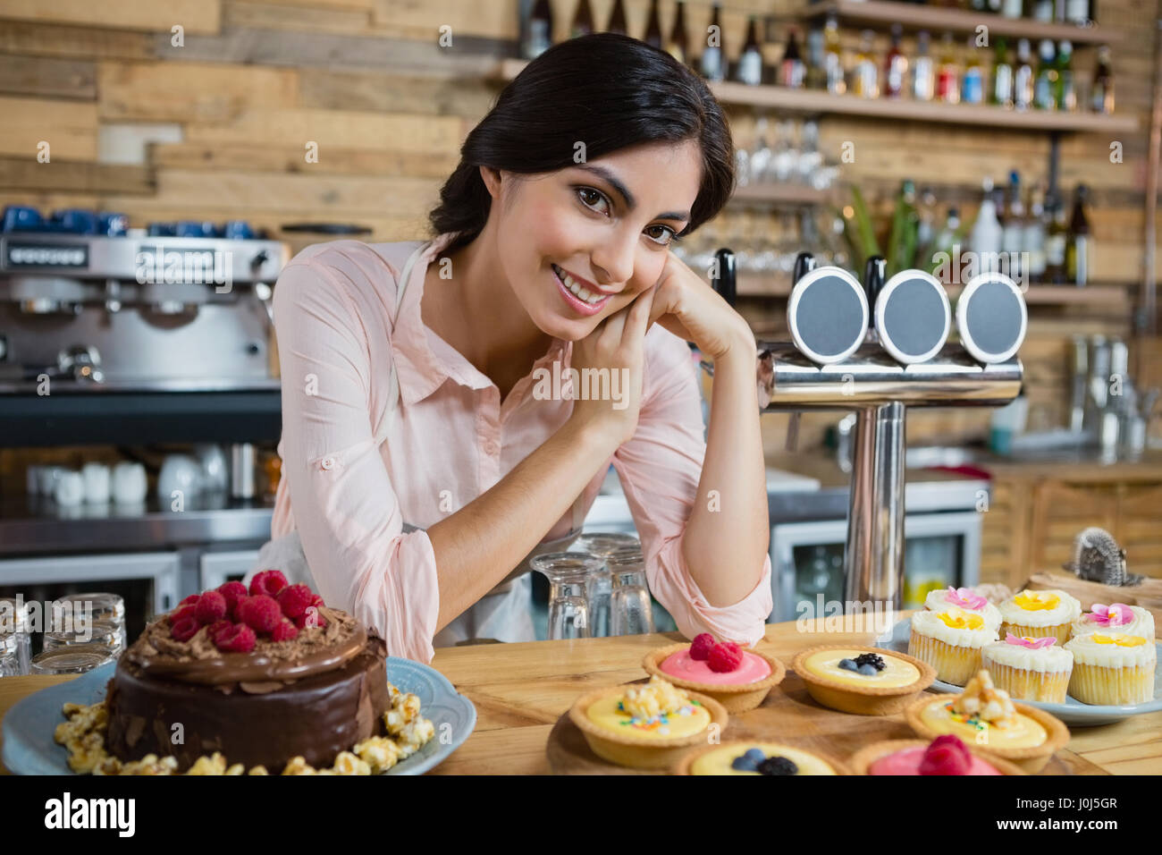 Portrait of waitress leaning at counter in cafÃƒÂ© Stock Photo - Alamy