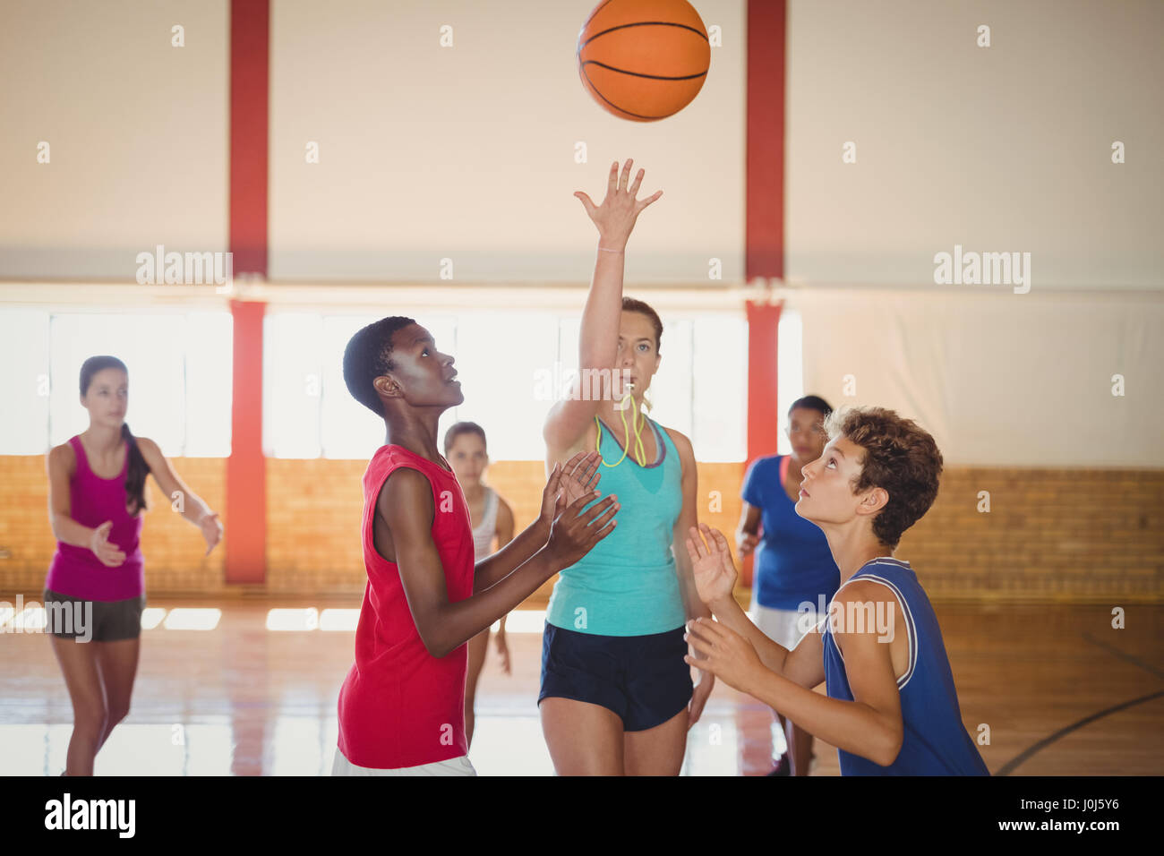 Determined high school kids playing basketball in the court Stock Photo ...