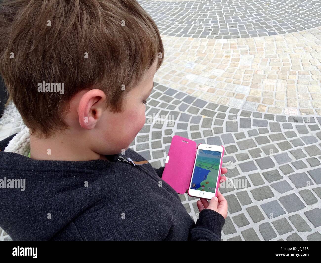 Young boy playing Pokémon Go Stock Photo - Alamy