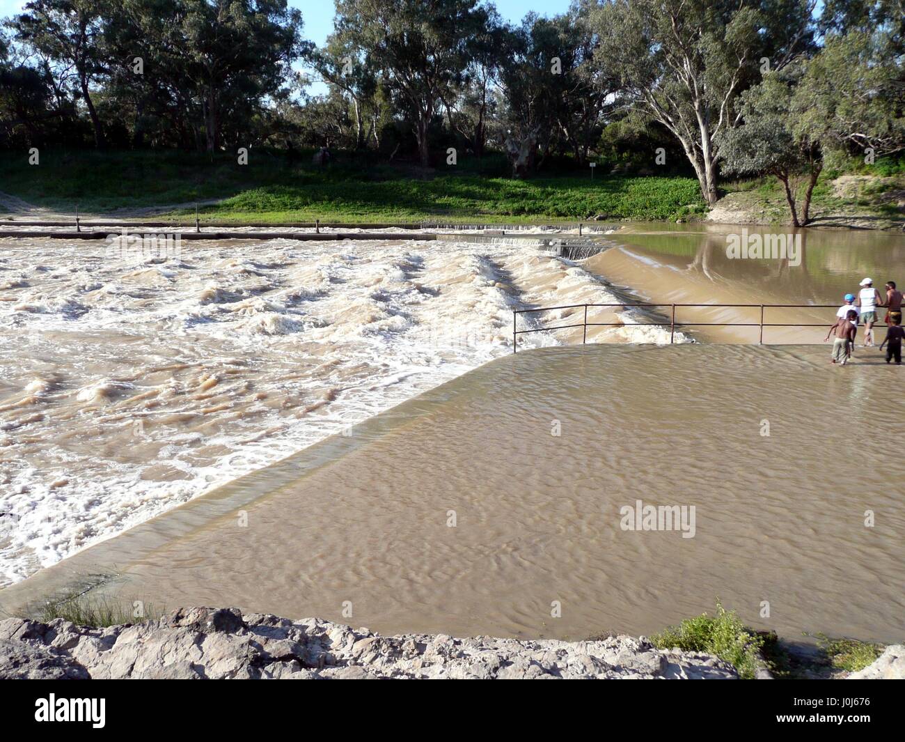 Weir alongside a lock Stock Photo - Alamy