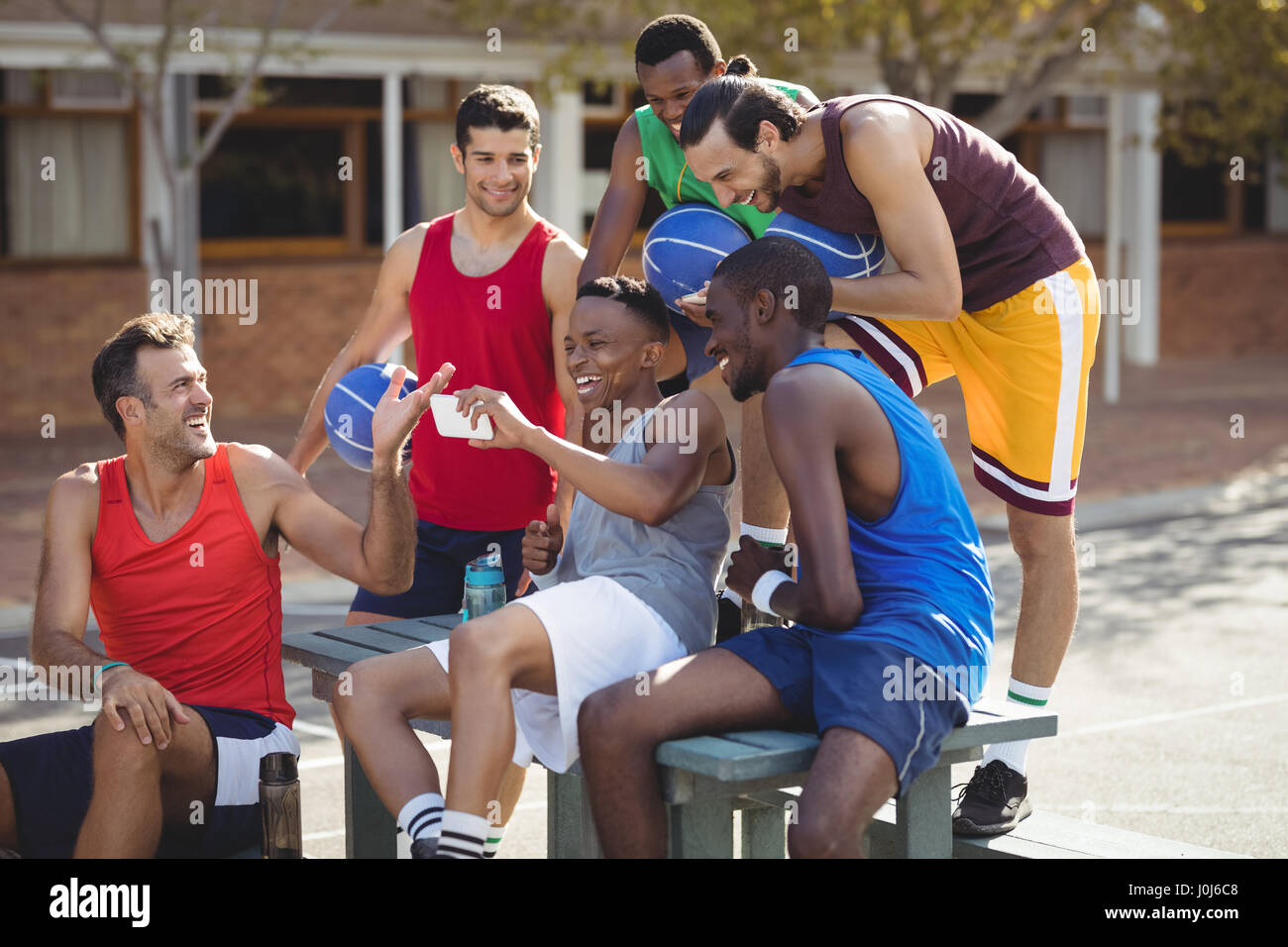 Basketball players taking a selfie in basketball court outdoors Stock ...