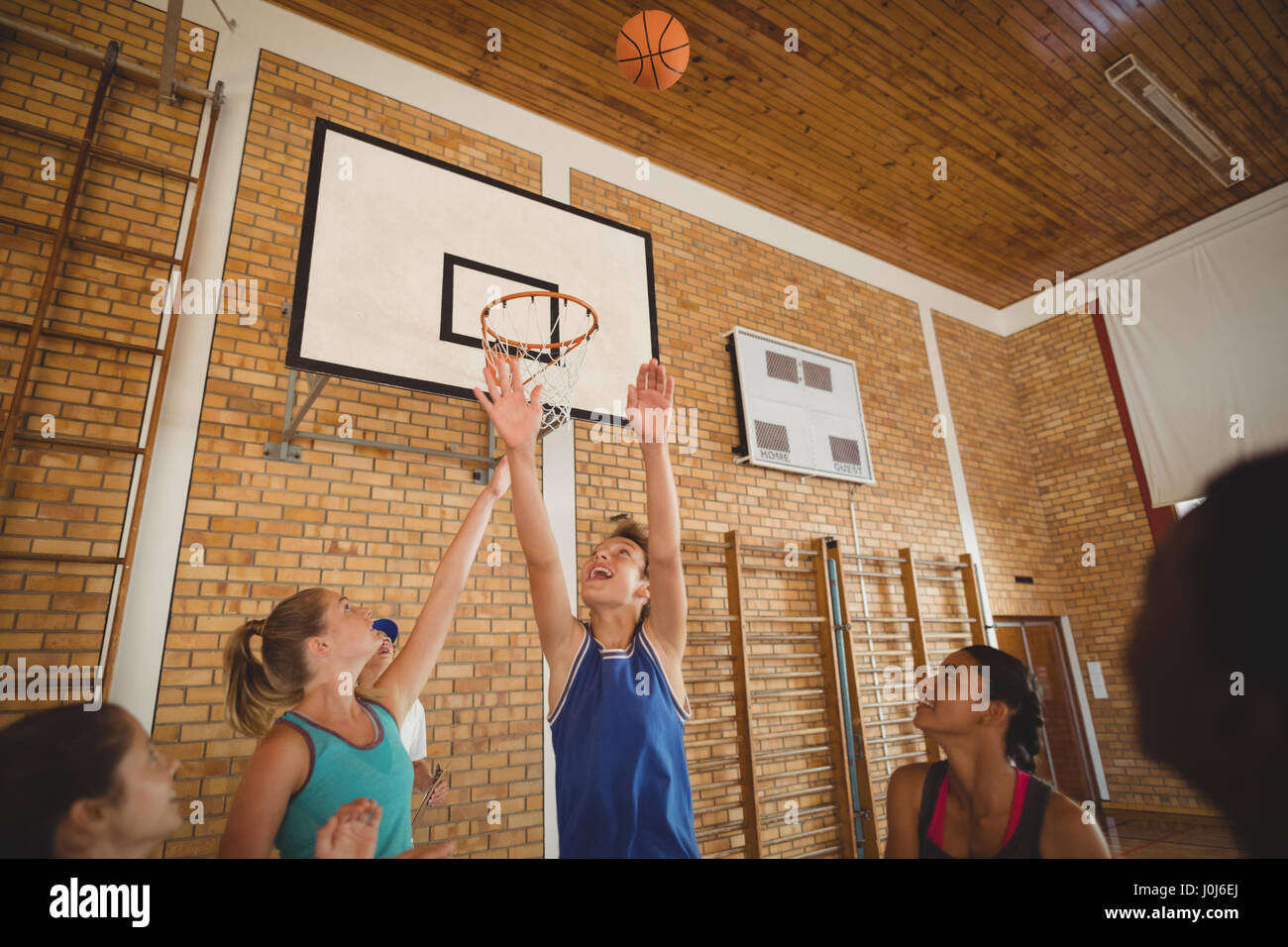 Excited high school kids scoring a goal while playing basketball in the ...