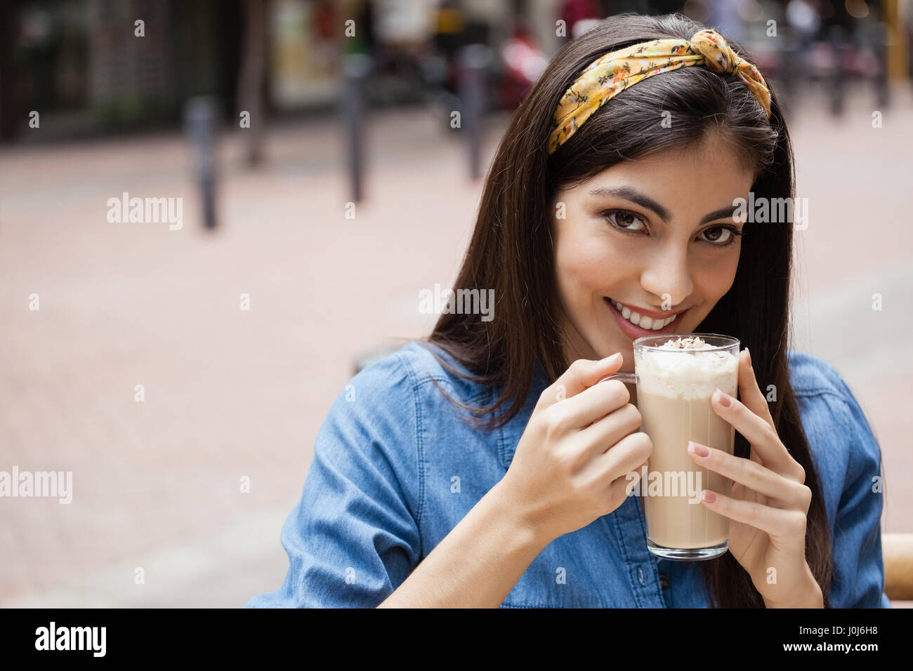 Portrait of smiling beautiful woman drinking cold coffee Stock Photo ...