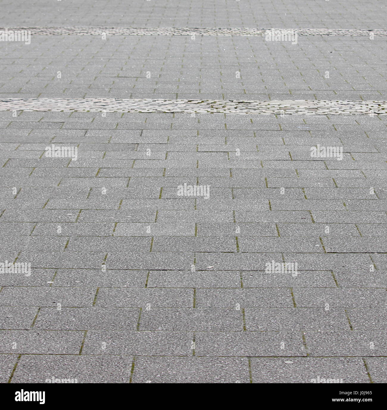 Paving stones and cobbles, with diagonal lines of perspective reaching ...