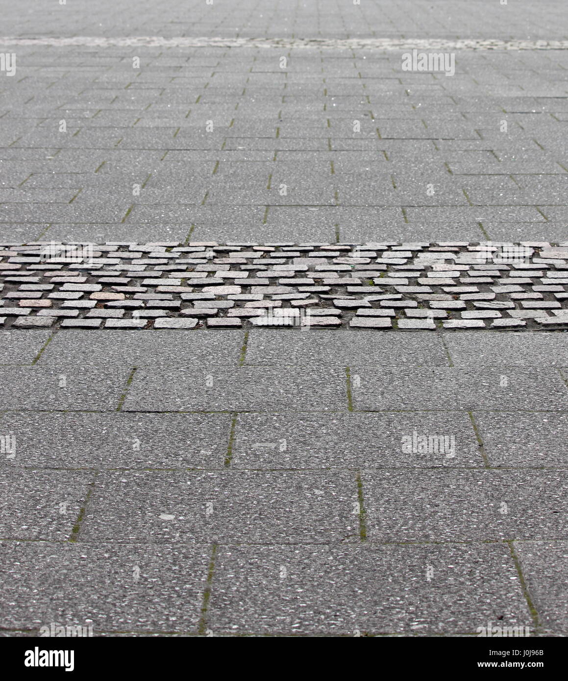 Paving stones and cobbles, with diagonal lines of perspective reaching ...