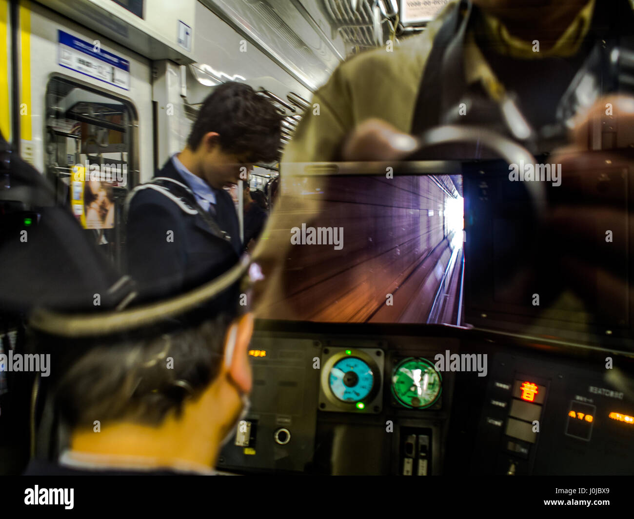 In a tunnel, the way ahead, and reflections of passengers and ...