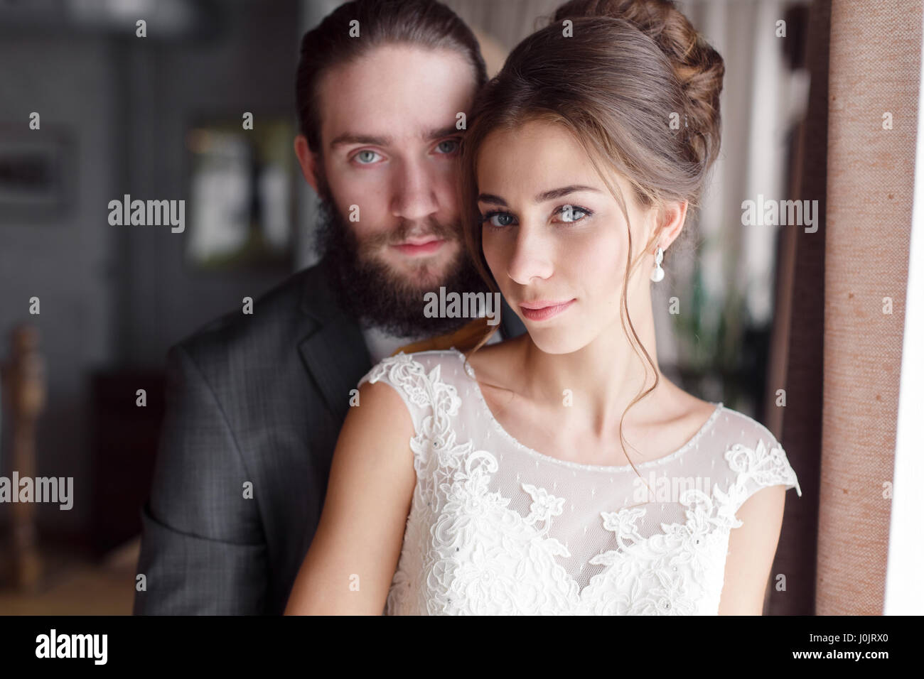 Portrait of the bride and groom close-up looking at the camera ...