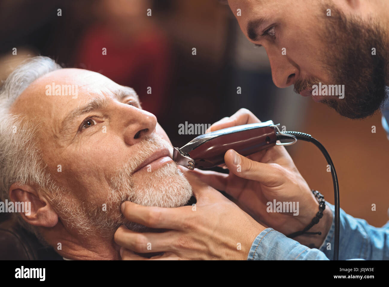 Delighted man getting groomed in the barbershop Stock Photo - Alamy