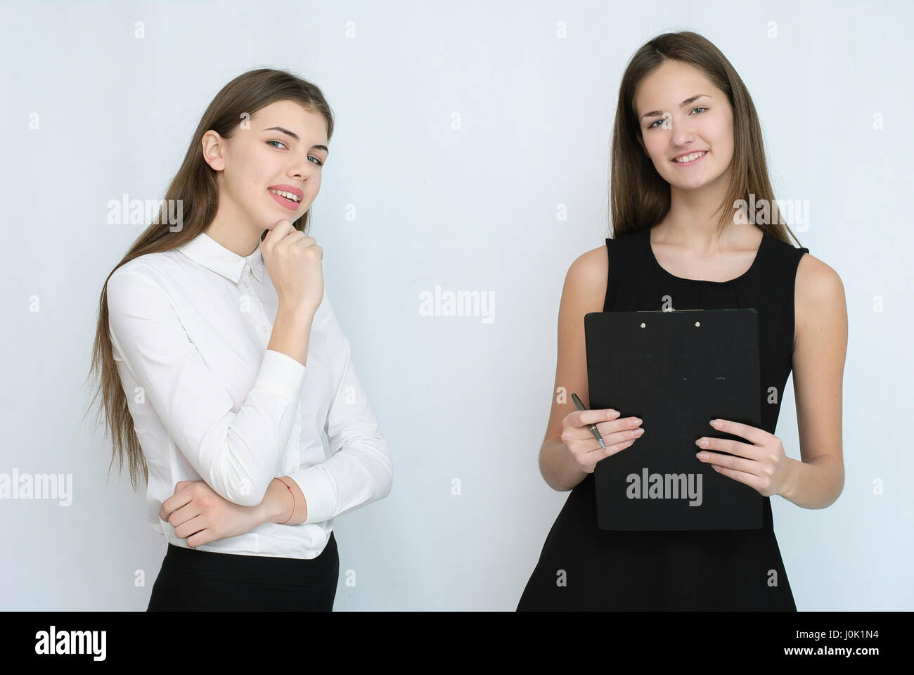 two business woman standing with their backs together Stock Photo - Alamy