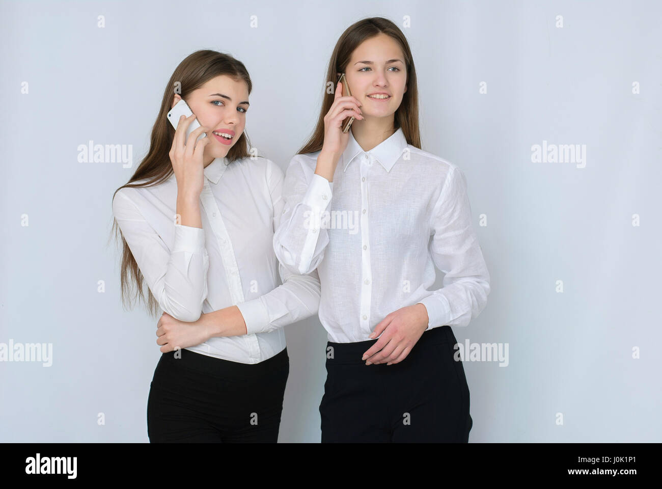 Isolated portrait of two young woman phone call. Isolated beautiful ...