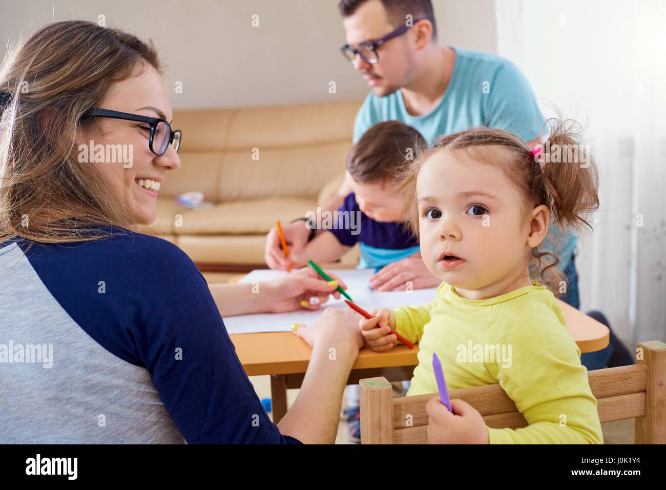 Parents and children draw together in the room Stock Photo - Alamy