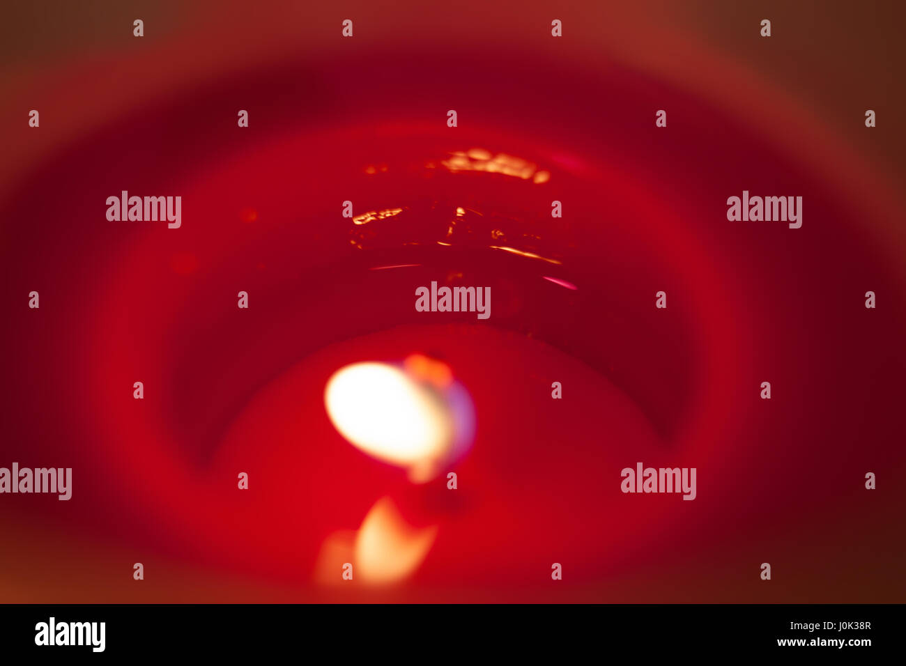 Red candle burning. Close-up, beautiful flame Stock Photo - Alamy