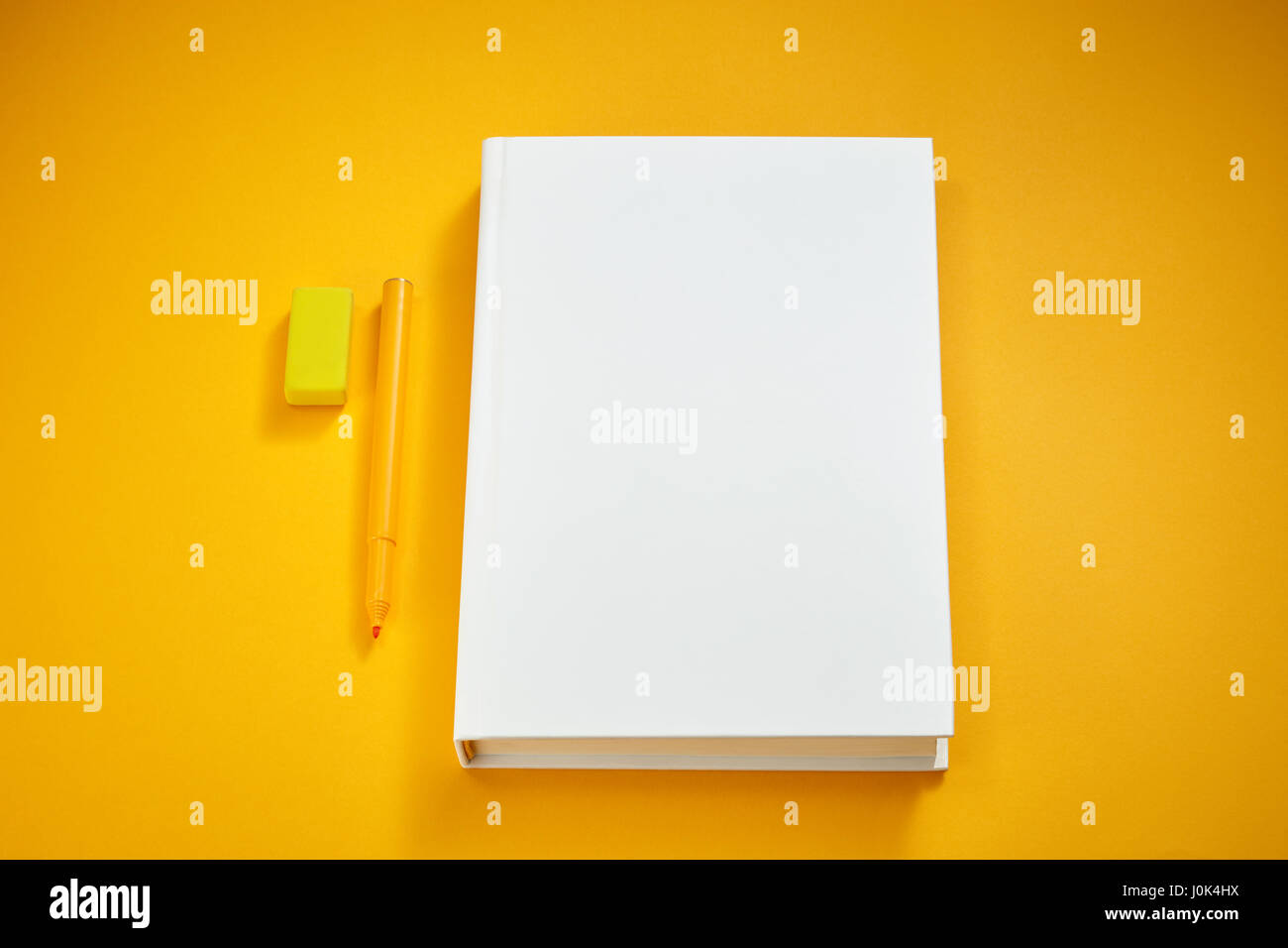 white book on the yellow background Stock Photo - Alamy