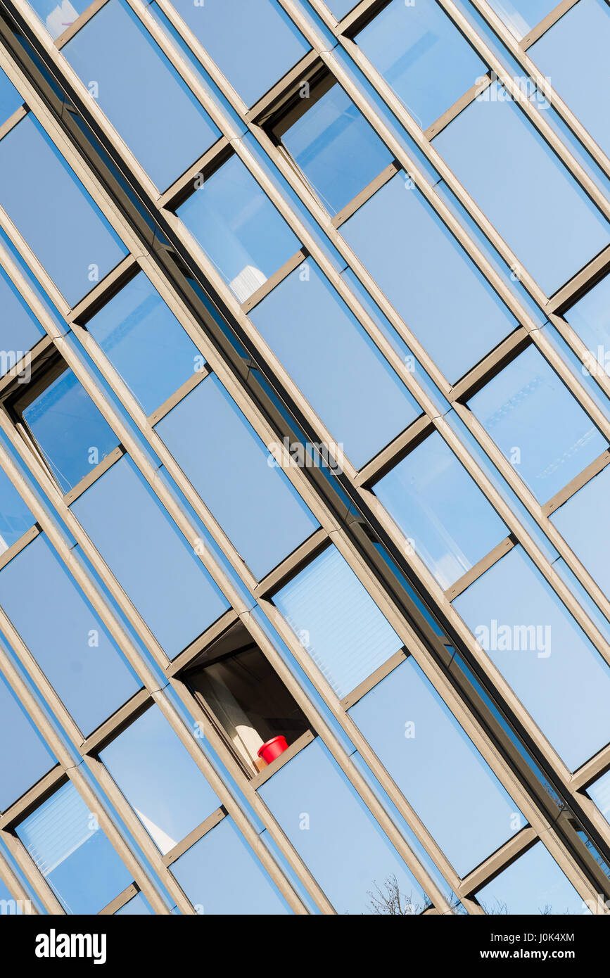 Red jar in a open window of a office building Stock Photo - Alamy